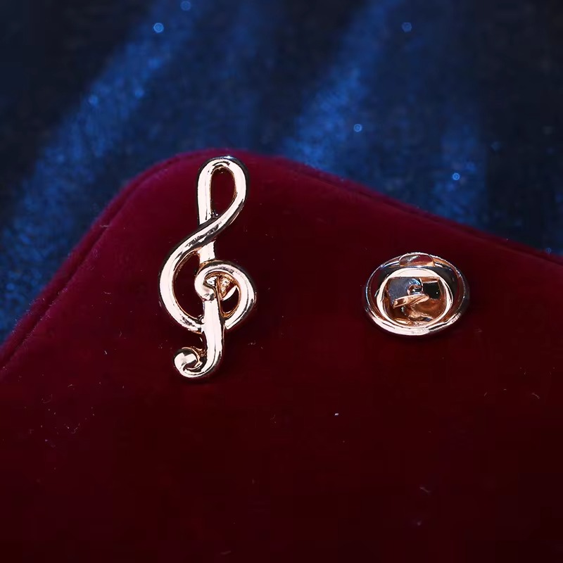 Pin nota musical dorada – Kumora Ties